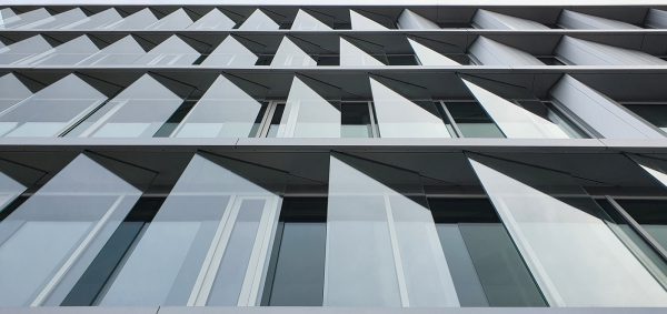 A low-consumption office building with a vertical glass louver facade ...